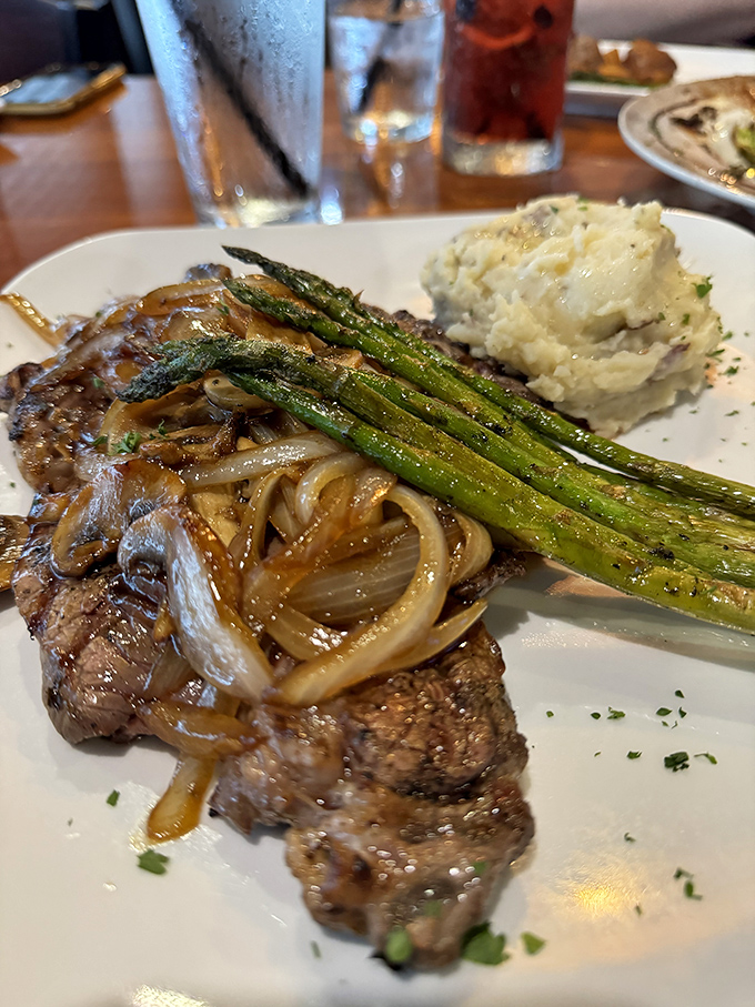A steak so good, even the sides are starstruck. Those asparagus spears are practically bowing in reverence.