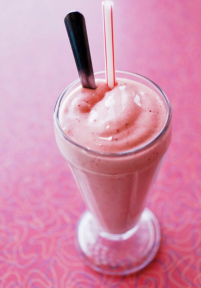 Pretty in pink and utterly delicious! This strawberry shake is summer in a glass. Brain freeze has never looked so tempting.