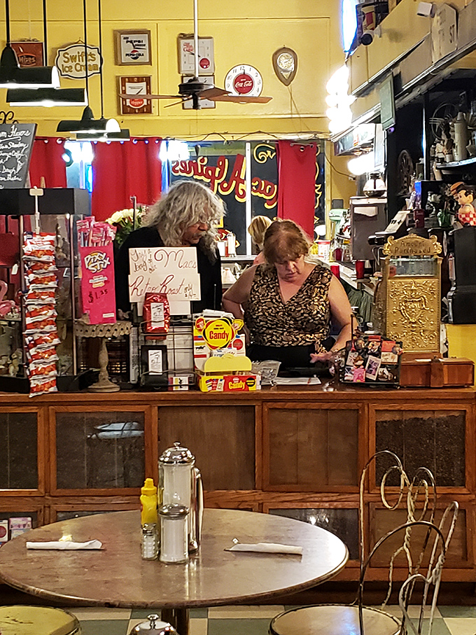 Meet the time-traveling taste-makers! These lovely ladies are the keepers of the flame, serving up nostalgia and deliciousness with a side of warm smiles.