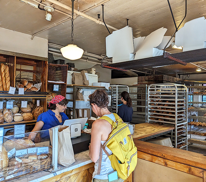 Behind the counter: culinary wizards at work, transforming flour and butter into edible magic. No wands required, just talented hands.