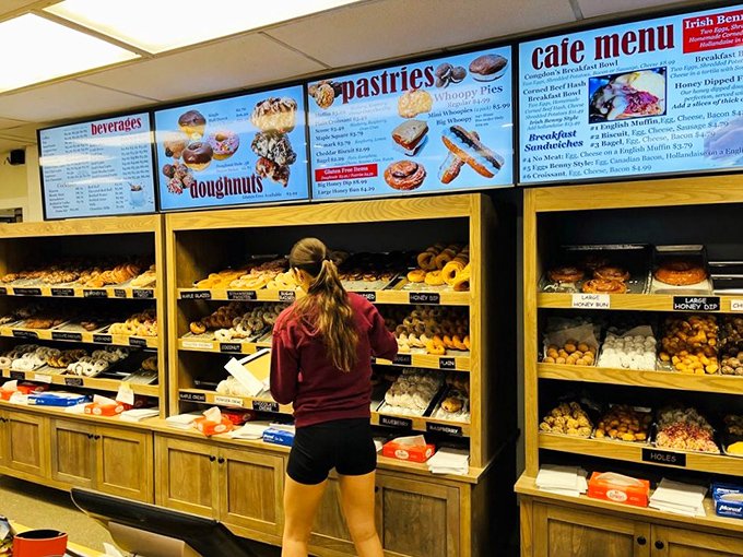 Behind the counter, where the magic happens. These doughnut whisperers are the unsung heroes of your morning sugar rush.