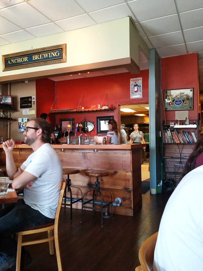 Behind the bar, where pizza dreams come true and the staff works their magic. It's like Hogwarts, but with more cheese.