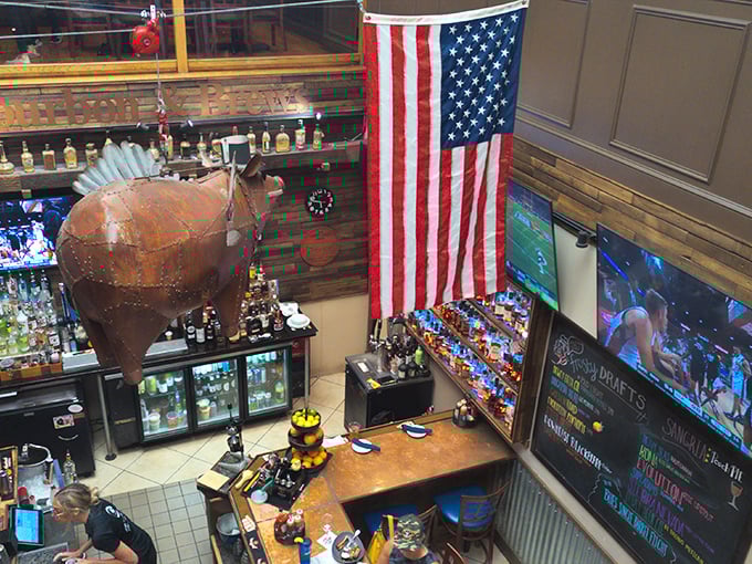 From this command center of liquid refreshment, bartenders orchestrate the perfect pairings for your smoked meat adventure, beneath a watchful copper pig.