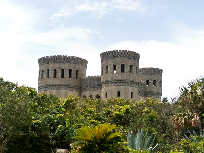 Triple the towers, triple the fun! This view showcases Castle Otttis in all its turreted glory, rising above the tropical foliage.