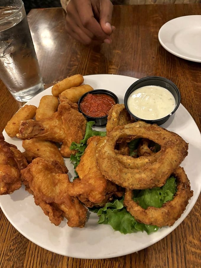 This appetizer sampler is the United Nations of fried goodness&mdash;onion rings, chicken tenders, and dipping sauces forming a delicious diplomatic summit.