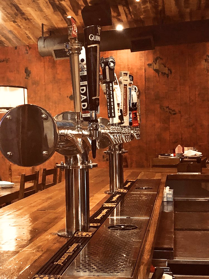 The gleaming beer taps stand ready like soldiers, each promising a perfectly pulled pint to complement those legendary comfort foods.