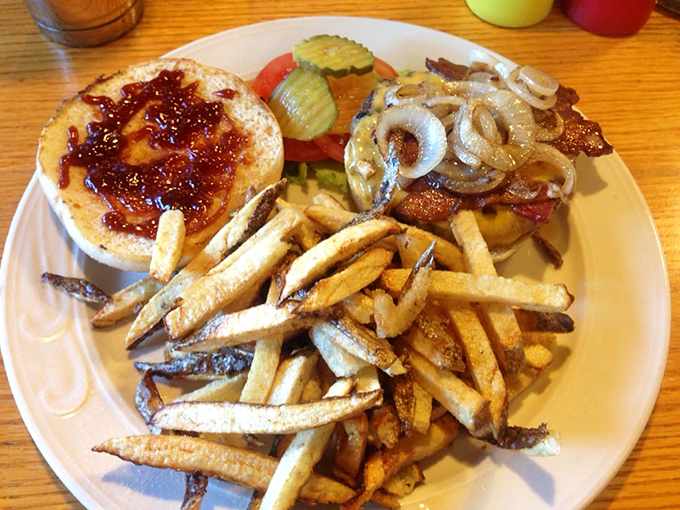 A burger that requires a game plan before the first bite, with fries that understand their supporting role but still deserve a standing ovation.