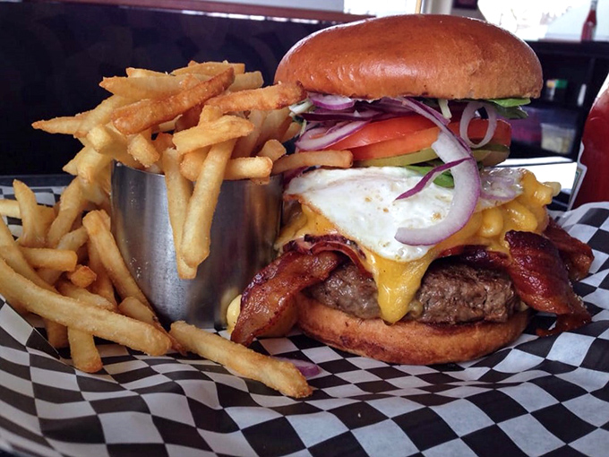 Burger lovers, meet your new obsession. This towering beauty isn't just a meal – it's a monument to the art of hand-held deliciousness.