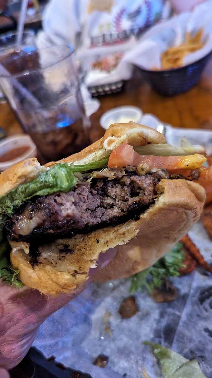 This burger is stacked higher than a Jenga tower. One bite and you'll be playing a delicious game of "How wide can I open my mouth?"