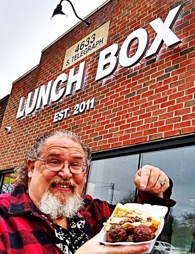 Sandwich enthusiasm personified! This happy customer's grin is wider than the Mississippi and twice as deep as the Grand Canyon.