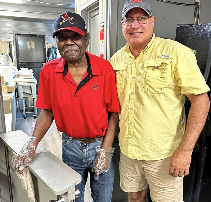 The image shows two men in the kitchen area of Jones Bar-B-Q Diner.
