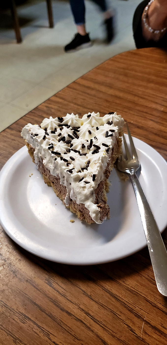 A slice of heaven, topped with a cloud of whipped cream. This pie could make even the toughest food critic weak in the knees.