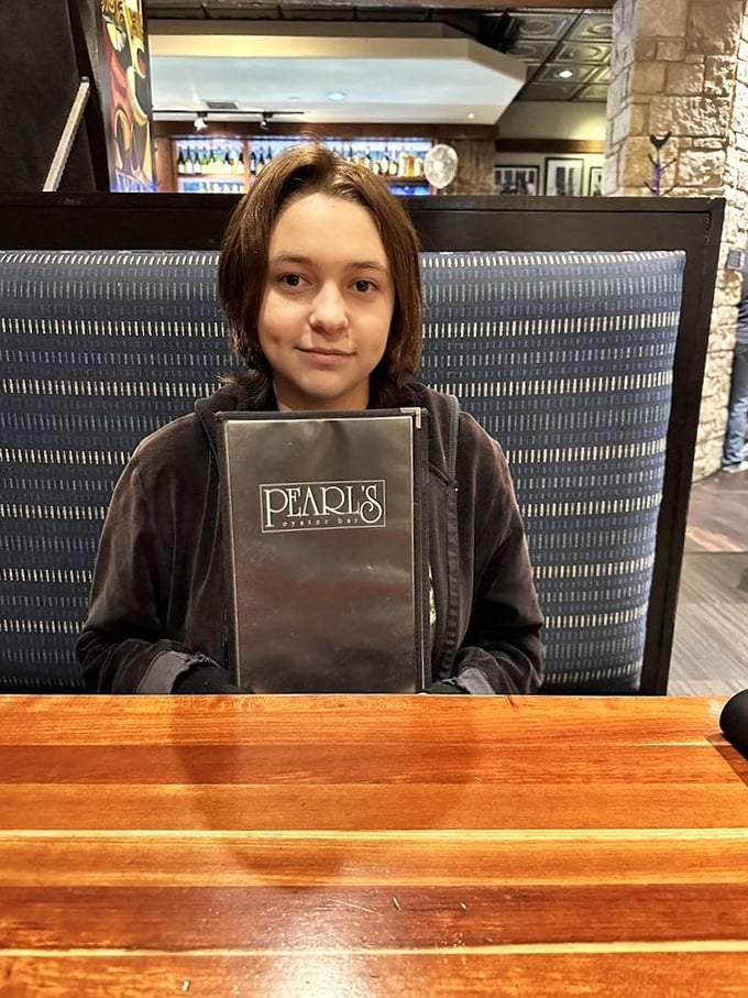 Menu in hand, adventure on the horizon. This diner is about to embark on a tasty voyage.