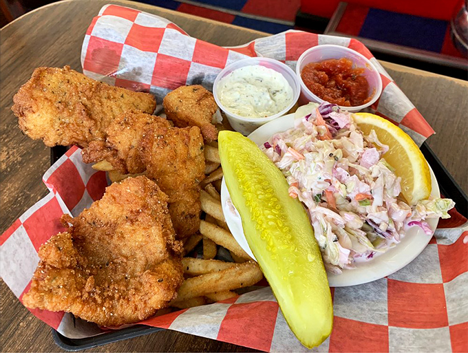 Fried fish so golden it could be currency, served with crispy fries and the kind of coleslaw that makes you reconsider your relationship with cabbage.