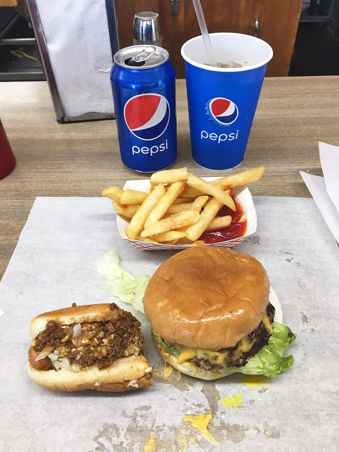 The holy trinity of diner delights! A perfect burger, crispy fries, and an ice-cold Pepsi &ndash; it's not just a meal, it's a religious experience.