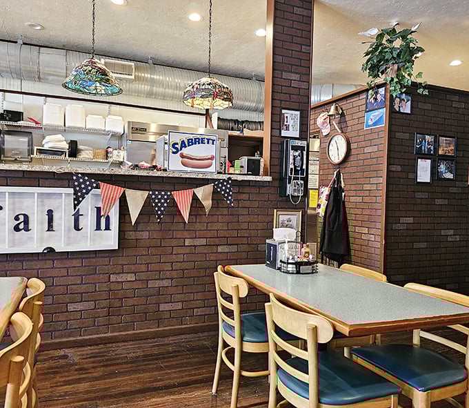 Stained glass lamps cast a warm glow over brick walls where sandwich artistry happens daily.