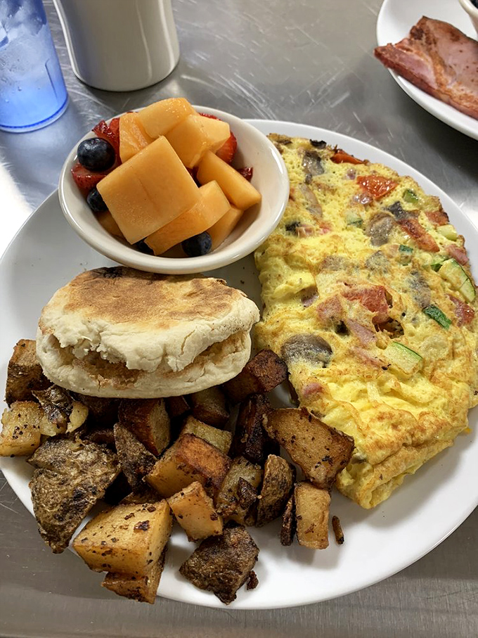 This isn't just an omelet; it's an egg-splosion of flavors. And those home fries? They're the unsung heroes of the plate.