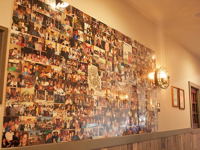 A wall of memories seasoned with salt air and butter. Each photo tells a tale of satisfied seafood lovers.
