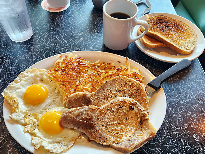 Pork chops and eggs: the dynamic duo of breakfast. It's like Batman and Robin, if Batman was juicy and Robin was sunny-side up.