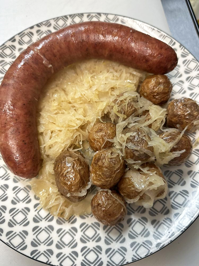 A plate that screams "Midwest comfort"! This hearty combo of sausage, kraut, and potatoes is like a warm hug for your stomach.