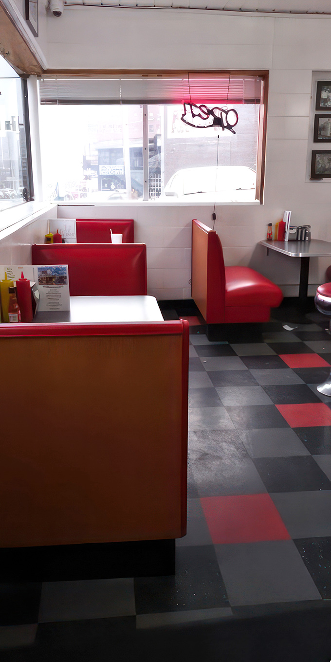 Cozy booths, checkered floors, and the promise of good eats – it's like stepping into an Edward Hopper painting, but with better burgers.