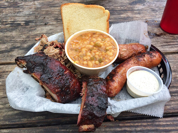 Behold the holy trinity of BBQ! This three-meat plate is like a flavor United Nations, bringing peace to your palate one bite at a time.