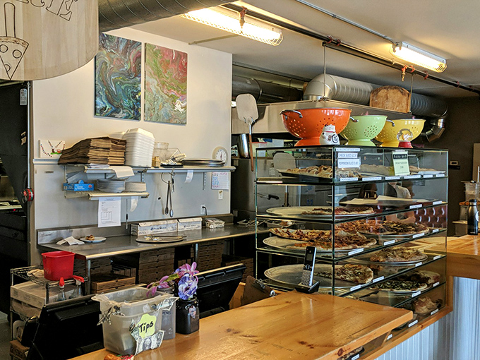 Behind the scenes of pizza perfection. It's organized chaos, like a conductor leading a symphony of sauces and toppings.