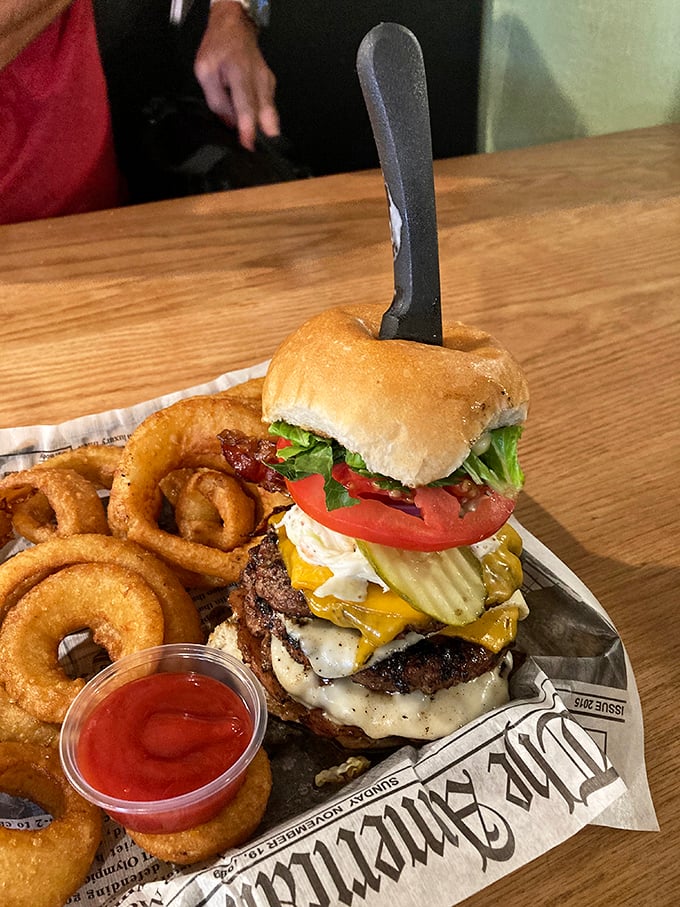 Holy cow! This burger isn't just stacked; it's a towering inferno of flavor that'll have you planning your next visit before the last bite.