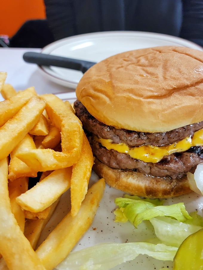 Burger bliss achieved! This towering beauty could make even the most dedicated health nut weak at the knees. Don't forget the crispy fries!
