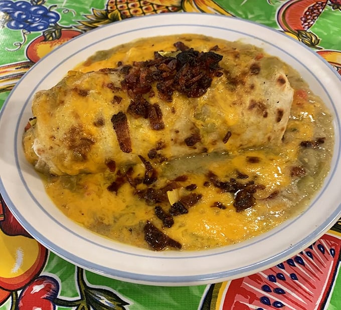 Burrito or flavor bomb? This cheese-covered, bacon-studded beauty is what breakfast dreams are made of. It's like a warm, edible hug that says, "Good morning, let's conquer the day!"