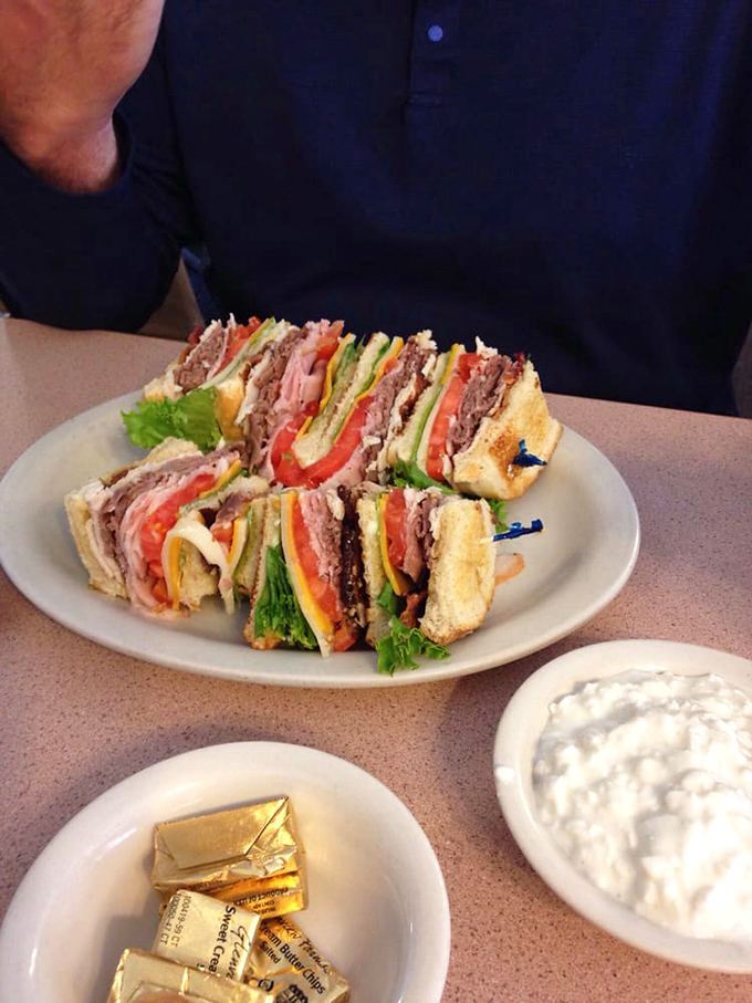 The Sandwich Tower of Power! This club sandwich stands tall and proud, daring you to unhinge your jaw for a perfect bite.