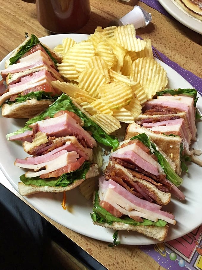 The club sandwich: tall, proud, and packed with more layers than a telenovela plot. It's a towering testament to sandwich engineering.