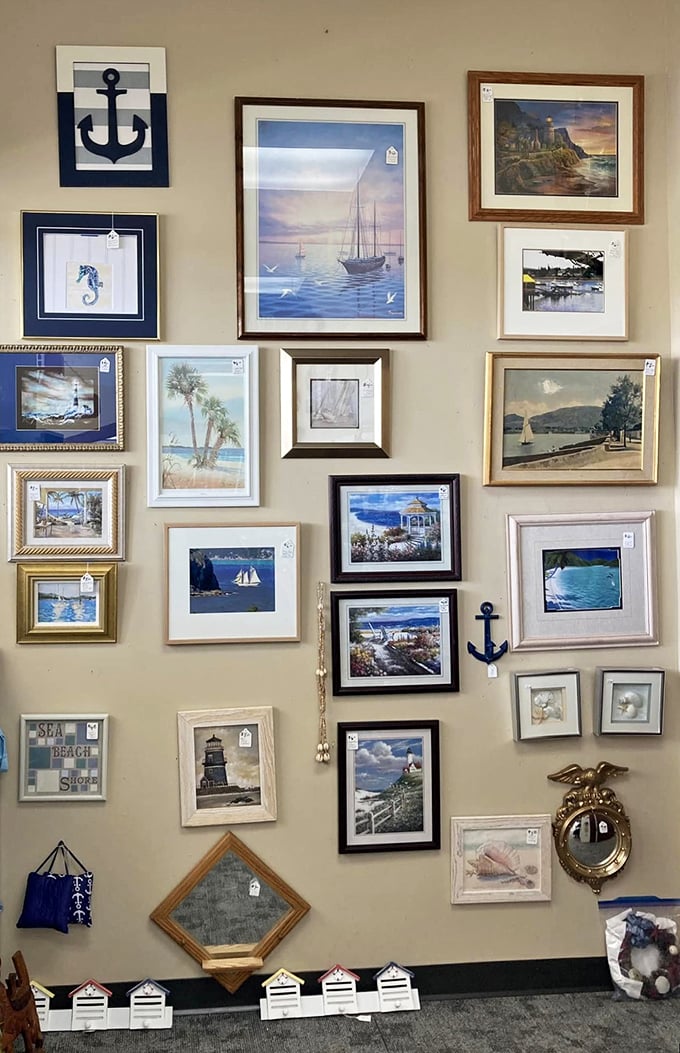 A wall of frames that's part art gallery, part time machine. It's like someone raided a coastal grandma's living room and turned it into a curated collection.