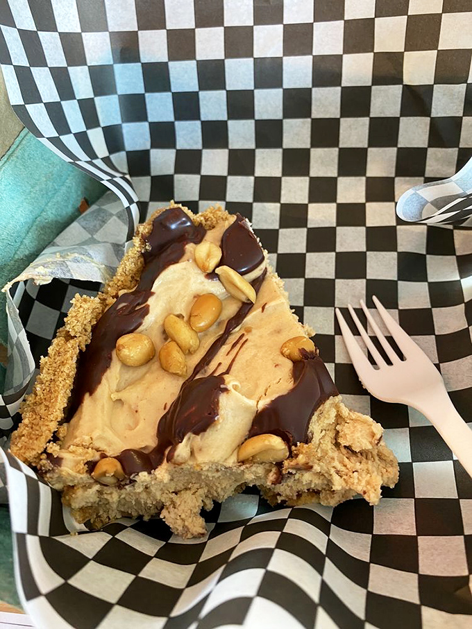 Peanut butter lovers, unite! This slice of heaven is a creamy dream come true, topped with a drizzle of chocolate that's simply nuts.