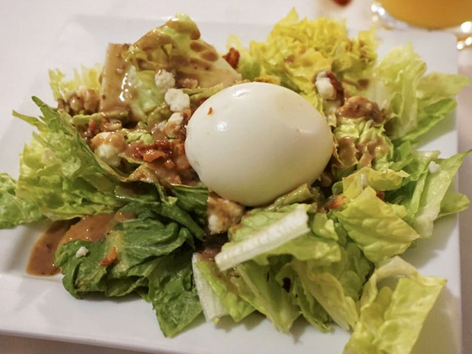 A salad so fresh and inviting, it could convert even the most devoted carnivore. That egg on top? It's the cherry on this garden of delights.
