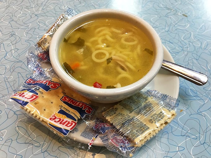 Chicken noodle soup that could cure anything from a common cold to existential dread, served with crackers and zero pretense.