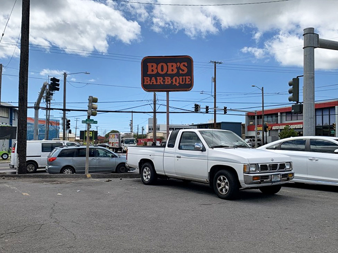 BBQ beacon of hope! Bob's sign stands tall, guiding hungry souls to a promised land of smoky delights and finger-licking fun.