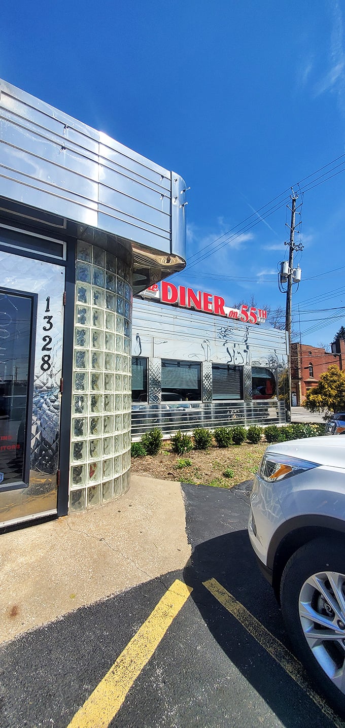 That curved glass block entrance says "Welcome to 1955" while the shining metal exterior promises timeless comfort inside.