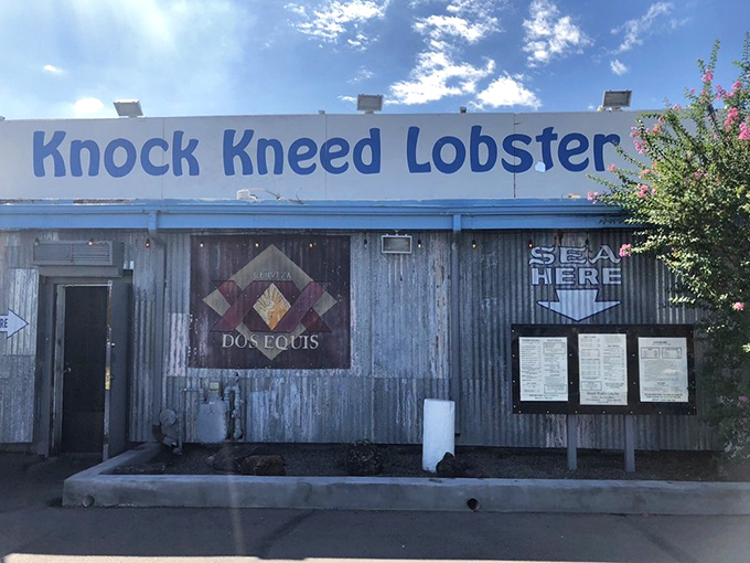 The exterior might say 'desert dive', but the sign promises seafood treasures within. It's like finding Atlantis in Arizona &ndash; who knew?