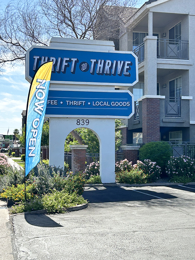 The siren call of secondhand treasures! This sign isn't just an invitation; it's a promise of coffee, local goods, and the thrill of the thrift hunt.