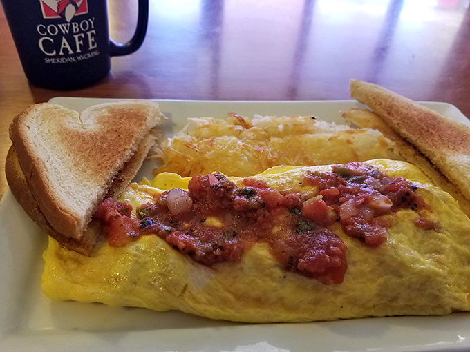 Behold, the breakfast of champions! This omelet is so fluffy, it might just float away if not anchored down by that hearty salsa.