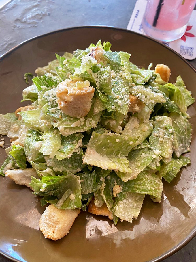 Caesar salad fit for an emperor! Crisp romaine bows before a shower of Parmesan, like subjects greeting their cheese overlord.