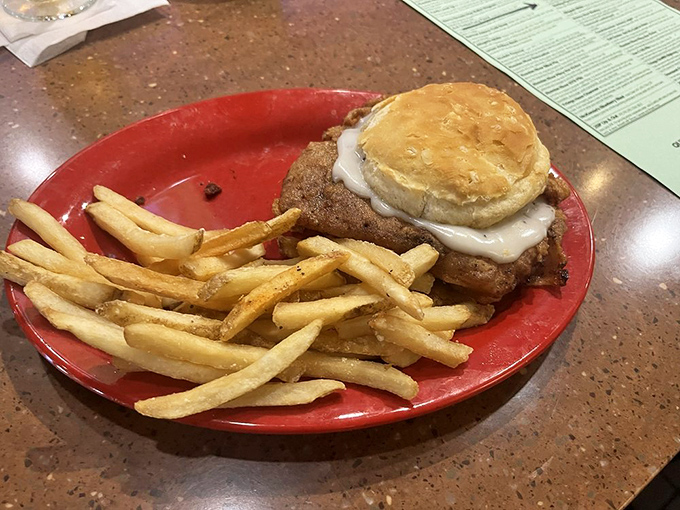 A burger that means business! This hearty handful is beefier than a bodybuilder's bicep and cheesier than a dad joke convention.