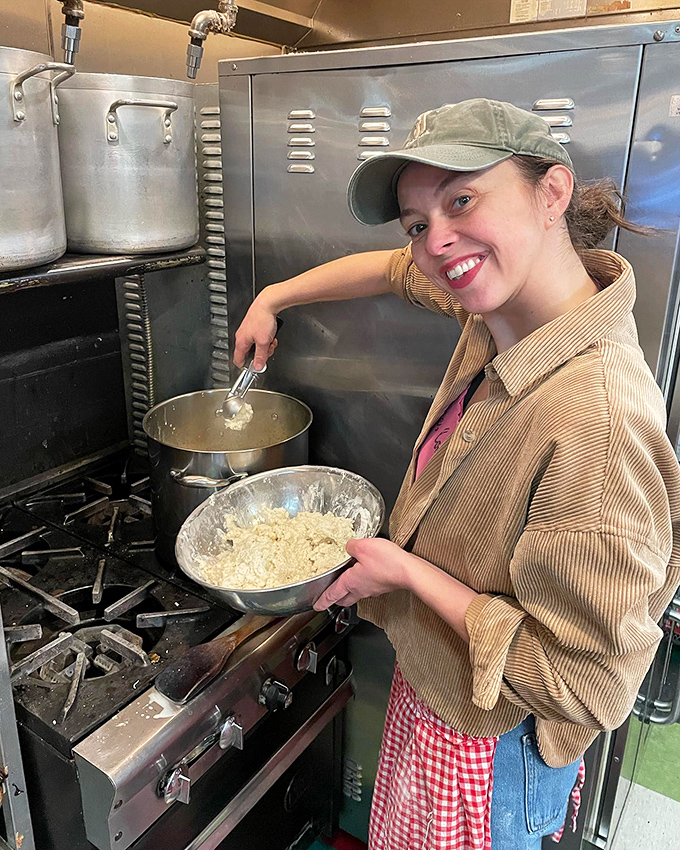 Behind the scenes of sweetness! This smiling baker is the wizard behind the curtain, conjuring up confectionery magic one bowl at a time.