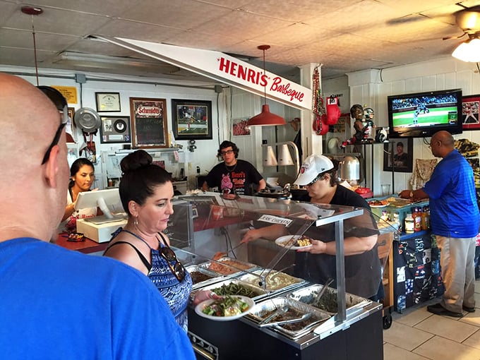 Where the magic happens! Henri's bustling counter is like watching a delicious ballet of barbecue in motion. Let the feast begin!