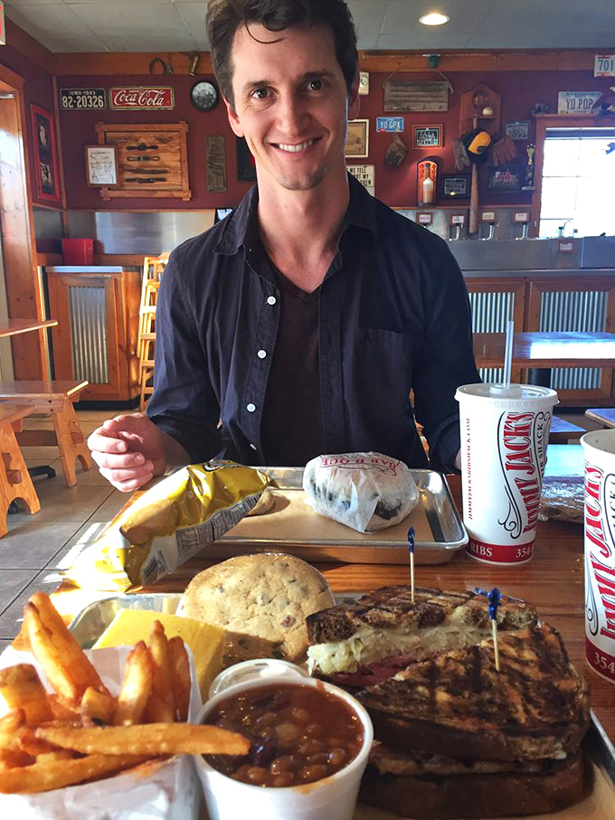 Happy camper alert! This diner's grin says it all – he's about to embark on a flavor adventure that'll make his taste buds sing with joy.