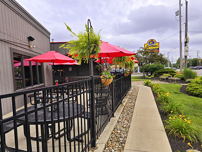 Red umbrellas and hanging plants: Because even a wing joint can have a touch of class. It's like a garden party, but with more napkins.