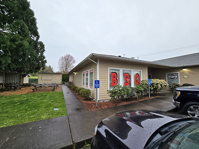 Even on a rainy Oregon day, that BBQ sign beckons like a lighthouse for the flavor-starved&mdash;proof that good barbecue transcends weather, geography, and mood.