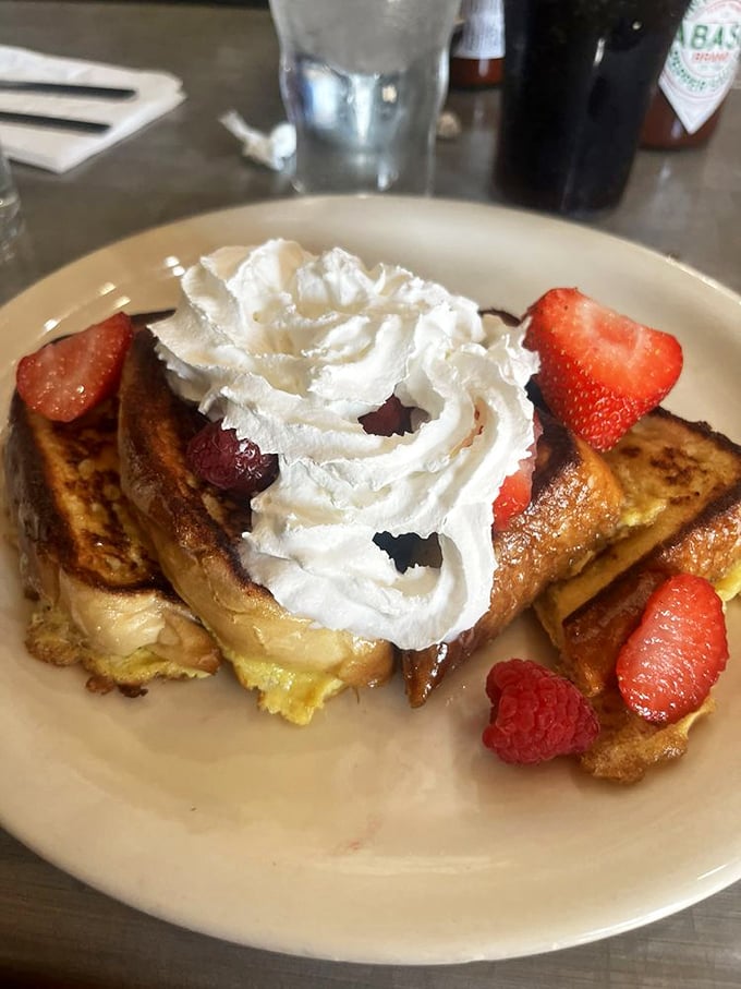French toast that's dressed to impress! Topped with fresh berries and cream, it's like breakfast and dessert had a beautiful baby.