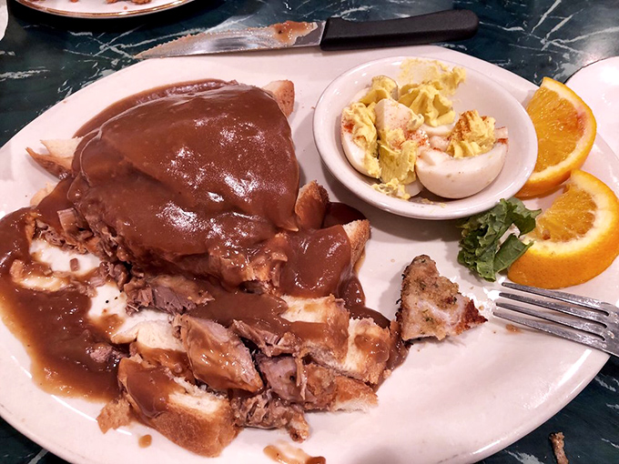 Holy cow, that's good beef! This hot roast beef plate is a carnivore's dream come true, smothered in gravy and served with a side of pure comfort.
